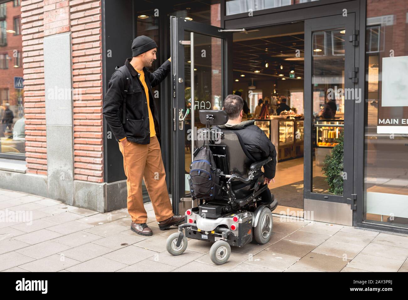 Man walking by cafe hi-res stock photography and images - Alamy