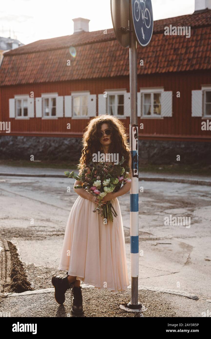 Woman standing near road sign Stock Photo - Alamy