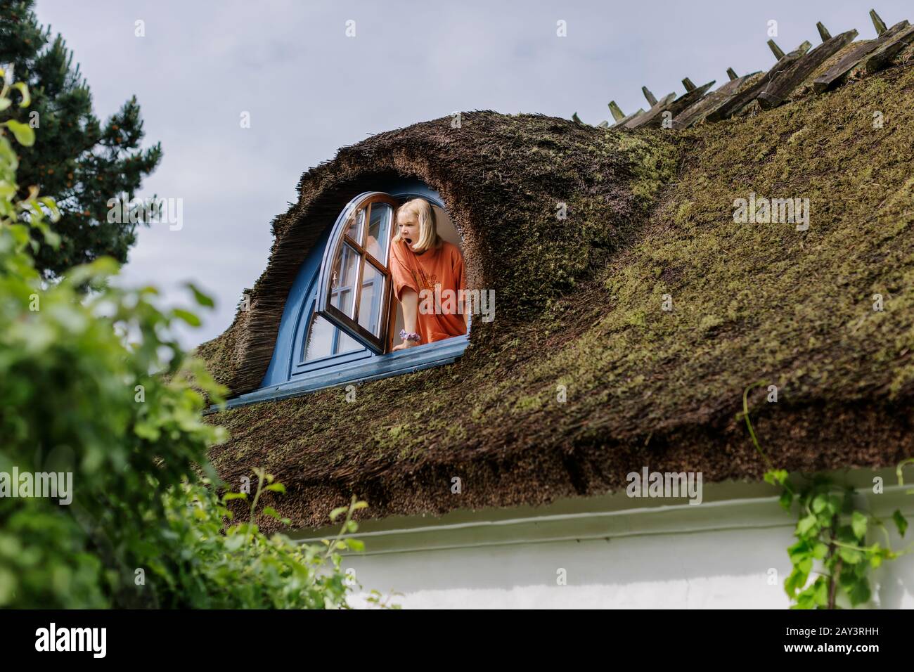 Woman looking through window Stock Photo - Alamy