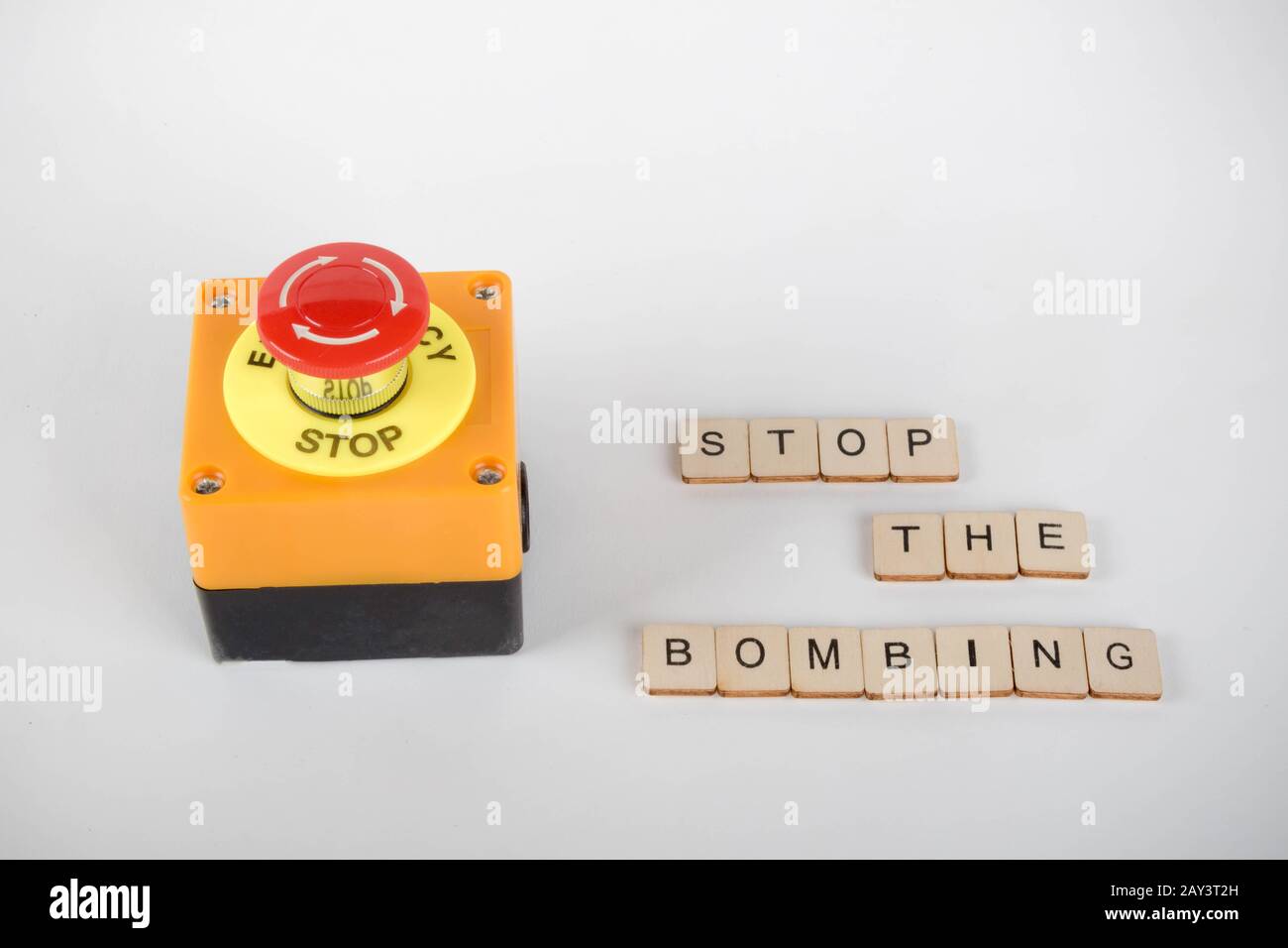 An industrial emergency stop button with a sign reading Stop The ...