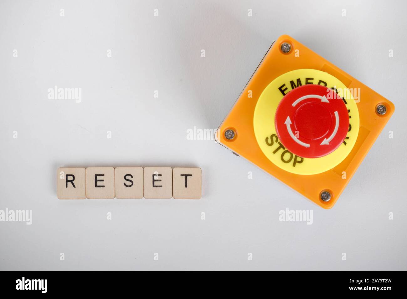 An industrial emergency stop button with a sign reading Reset Stock ...