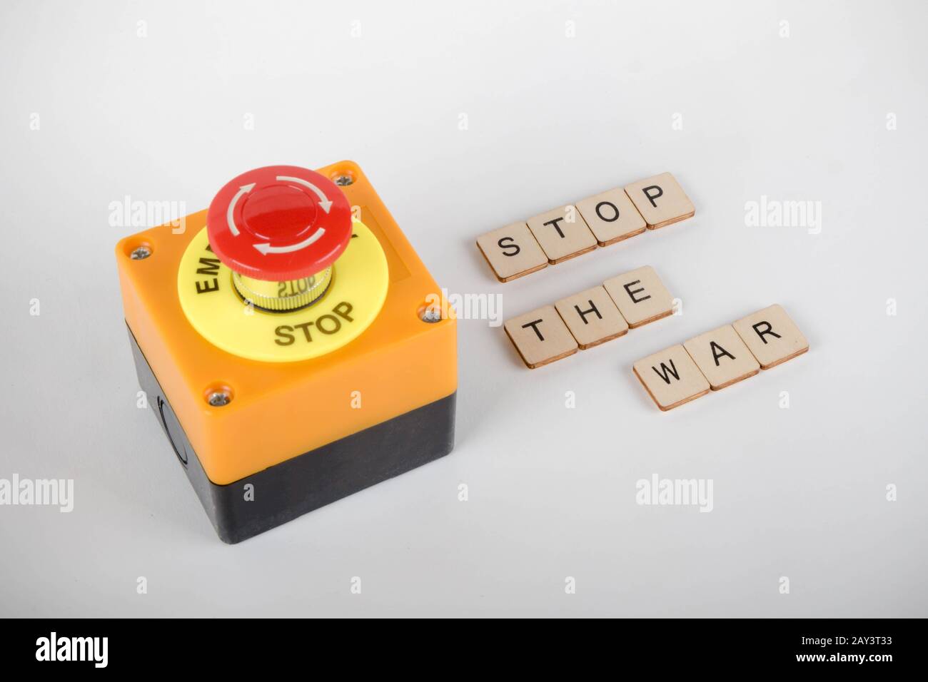 An industrial emergency stop button with a sign reading Stop The War ...