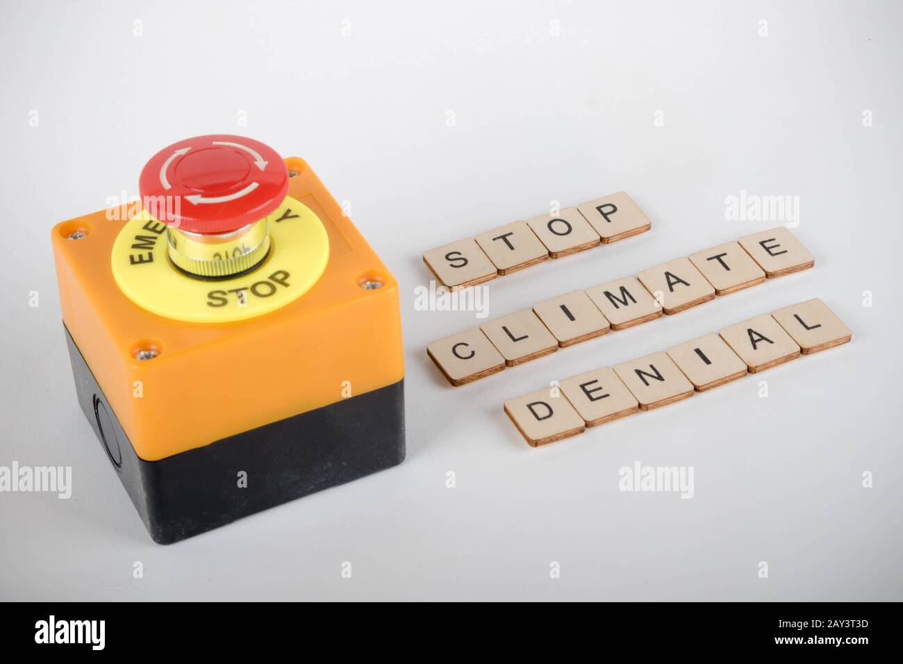 An industrial emergency stop button with a sign reading Stop Climate ...