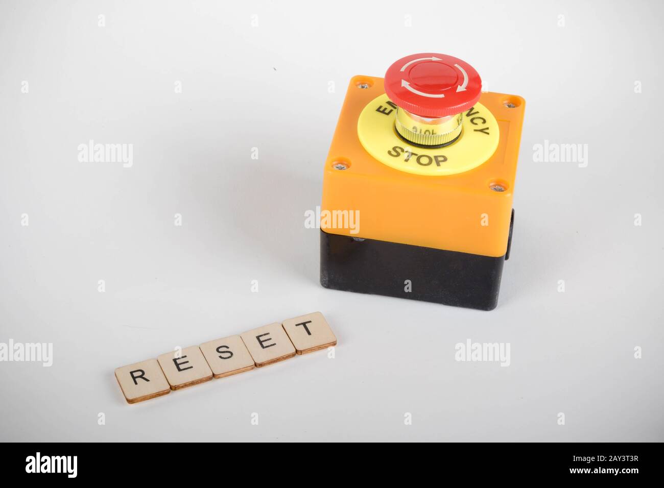 An industrial emergency stop button with a sign reading Reset Stock ...