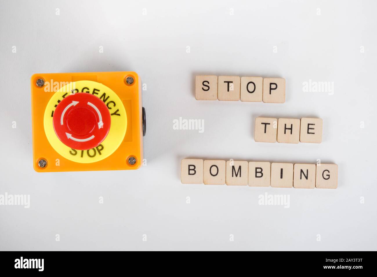 An industrial emergency stop button with a sign reading Stop The ...