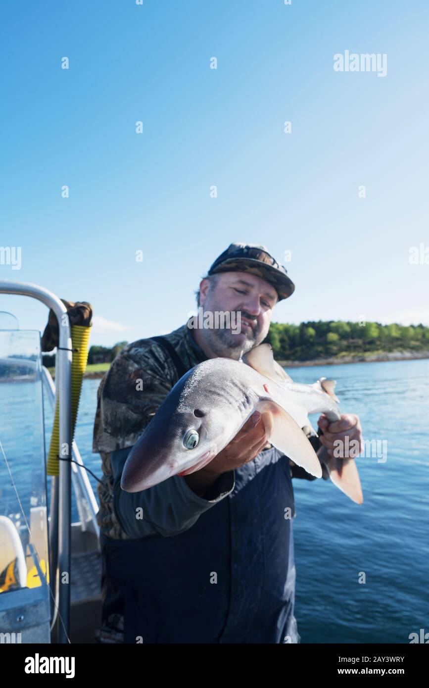 Person holding fish on boat hi-res stock photography and images - Alamy