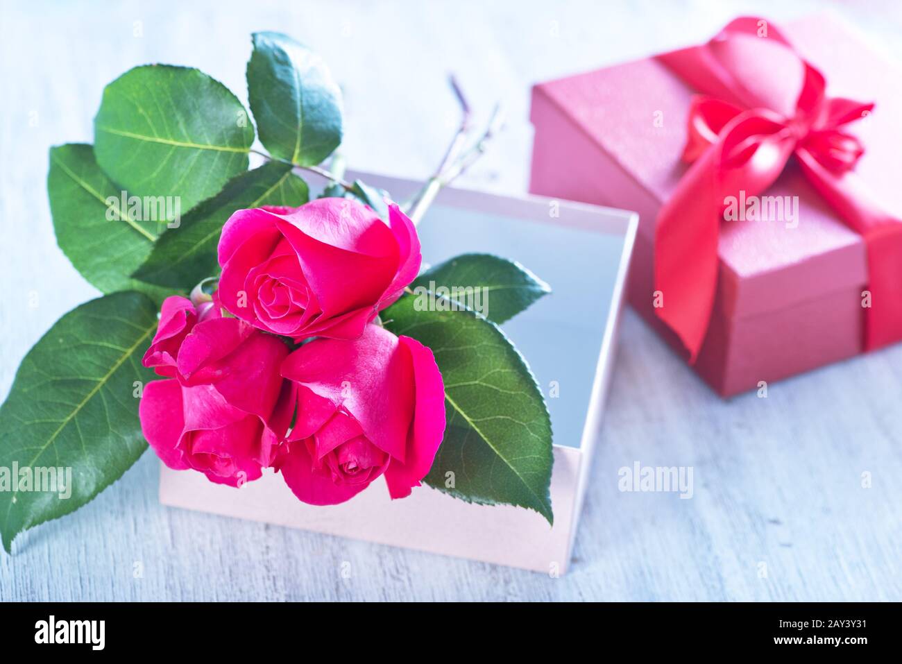 box for present and red roses Stock Photo - Alamy