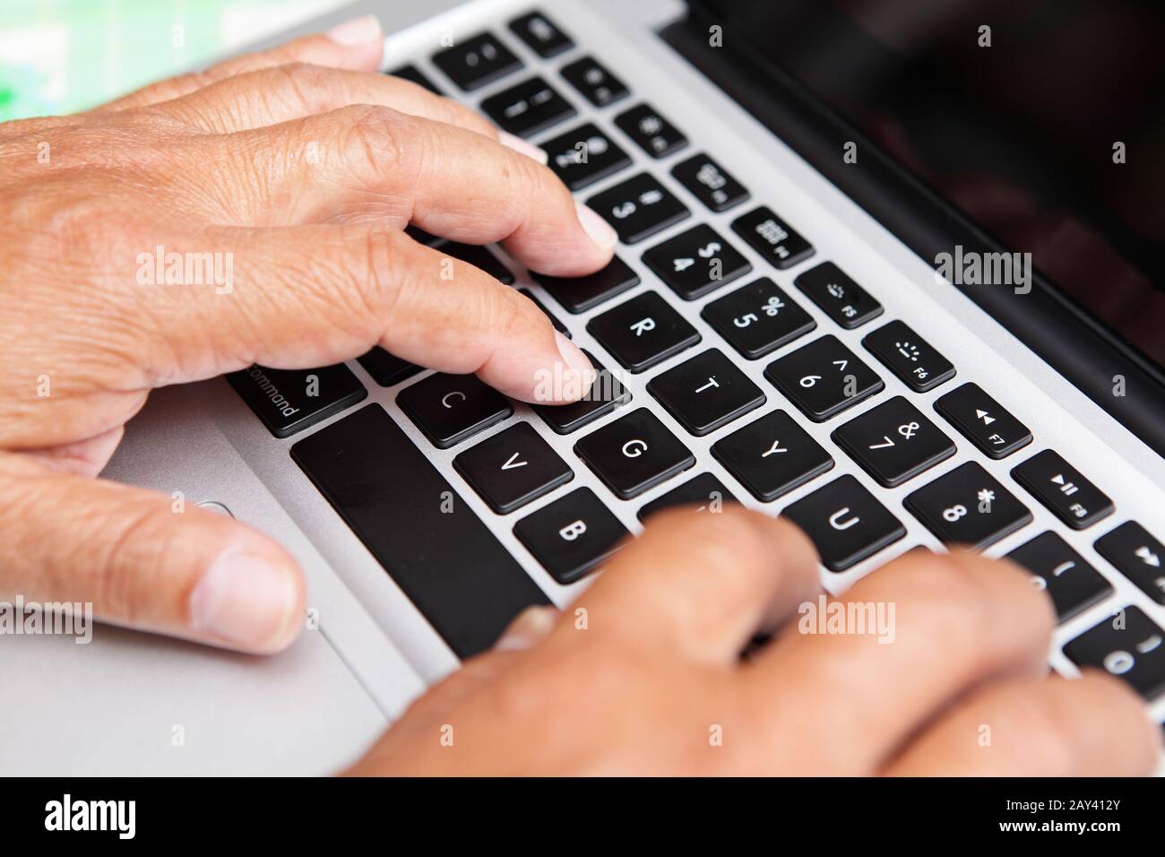 Hands of old man on computer Stock Photo - Alamy