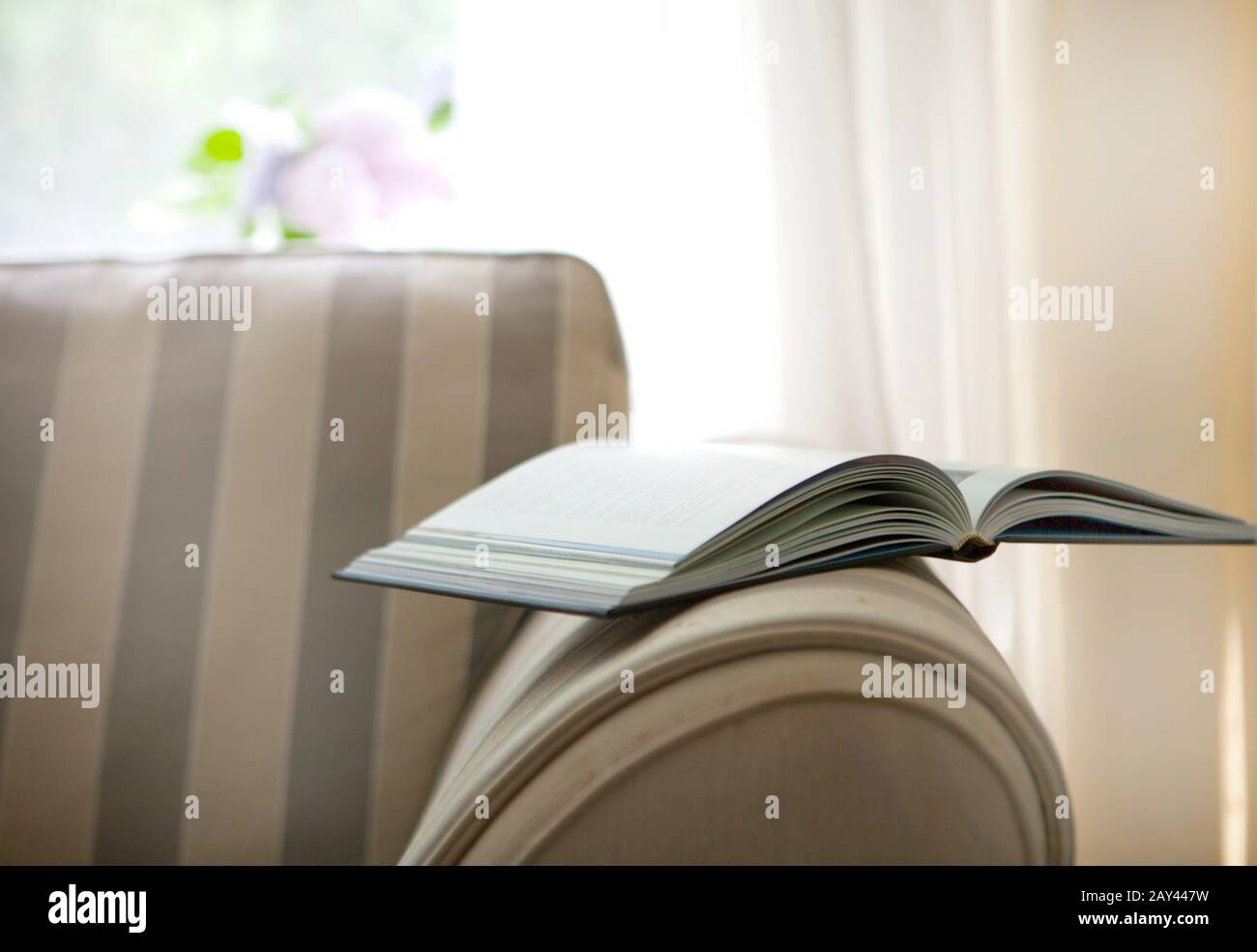 Book on the chair behind the window in a white cosy interior. vintage ...