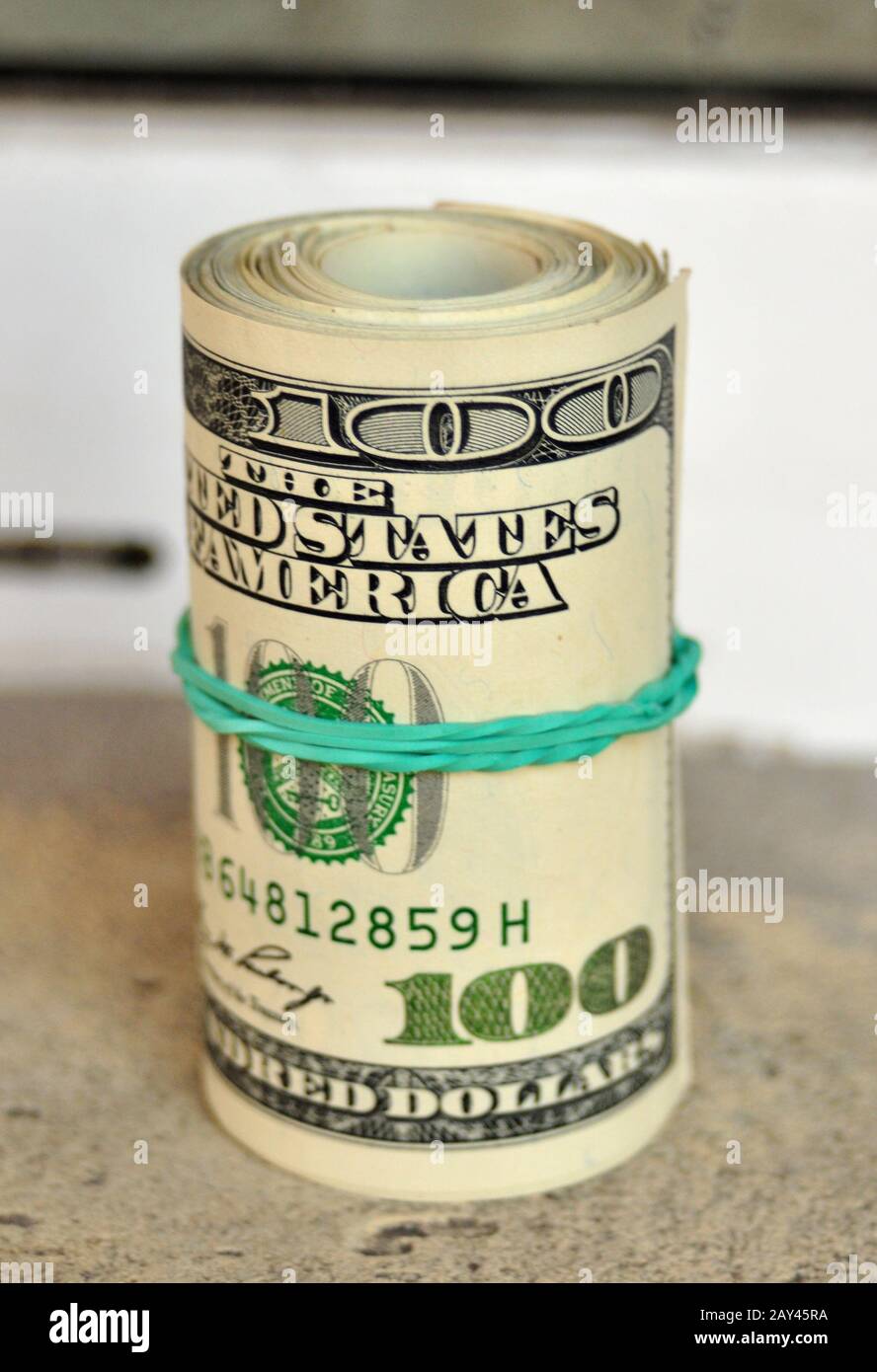 Roll of hundred dollars hi-res stock photography and images - Alamy