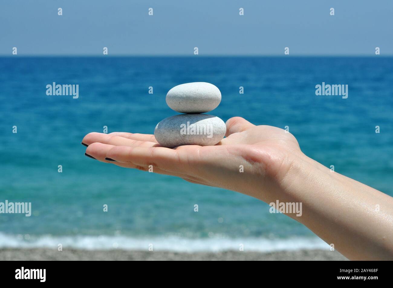 Zen stones hand Stock Photo - Alamy