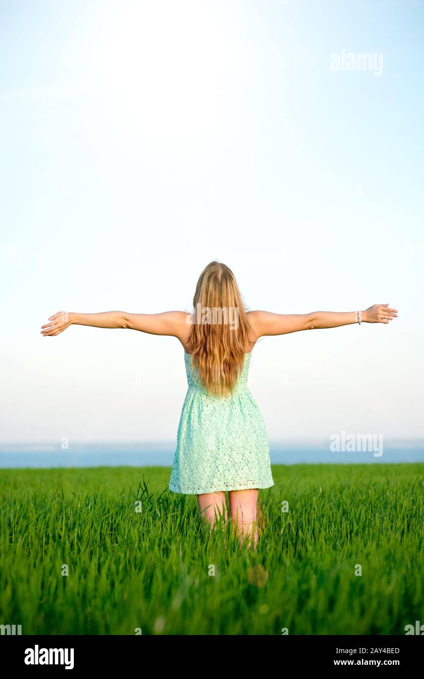 Happiness woman stay outdoor under sunlight of sunset Stock Photo - Alamy