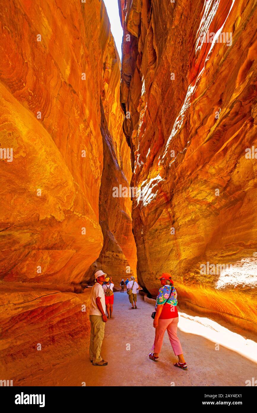 Petra, Jordan - May 23, 2009: Walking tourists in gorge between cliffs ...