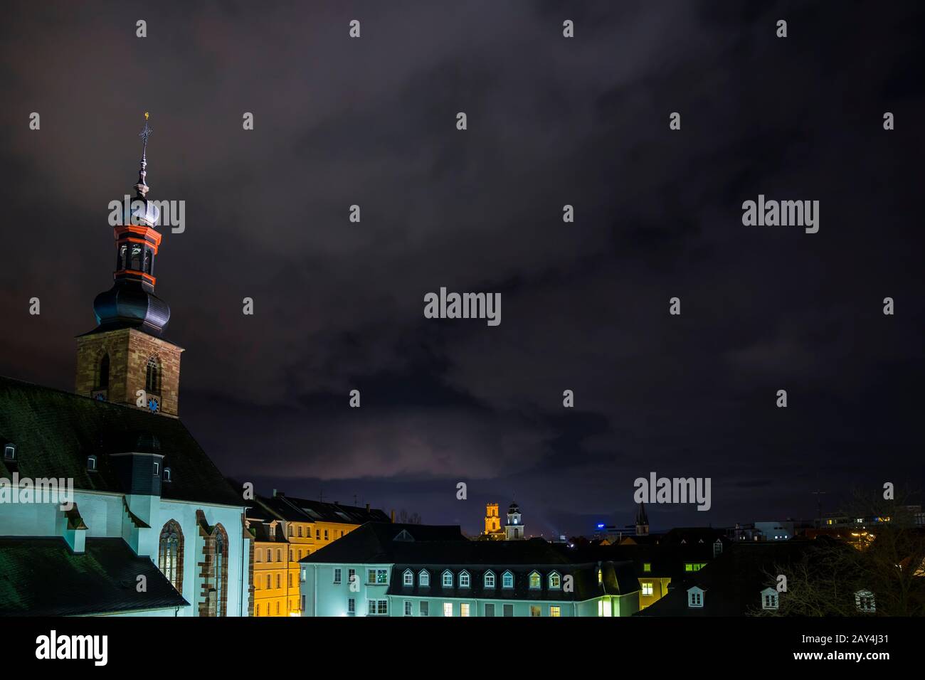 Germany, Magical night sky over roofs of downtown saarbrucken city and ...