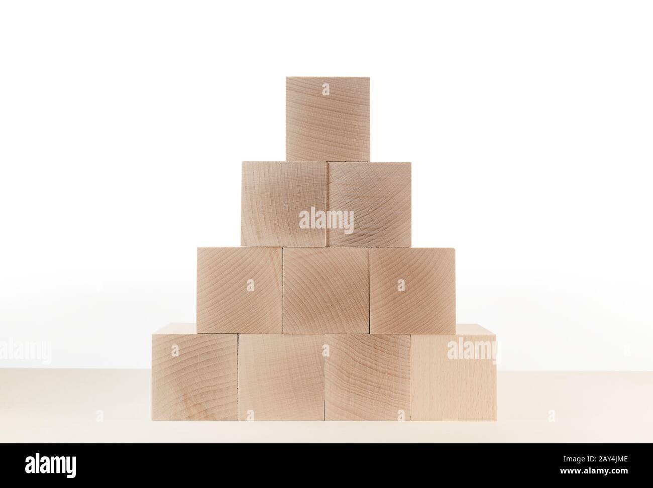 close-up of pyramid of wooden toy blocks against white background ...