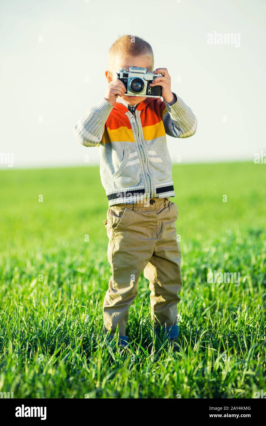 Little boy with an old camera shooting outdoor Stock Photo - Alamy