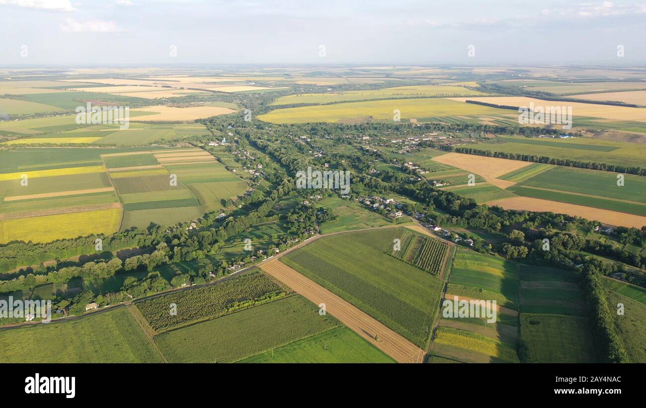 Aerial photography of a small settlement and its nature with fields and ...
