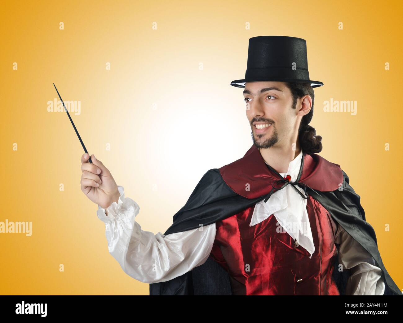 Magician doing tricks on white Stock Photo - Alamy