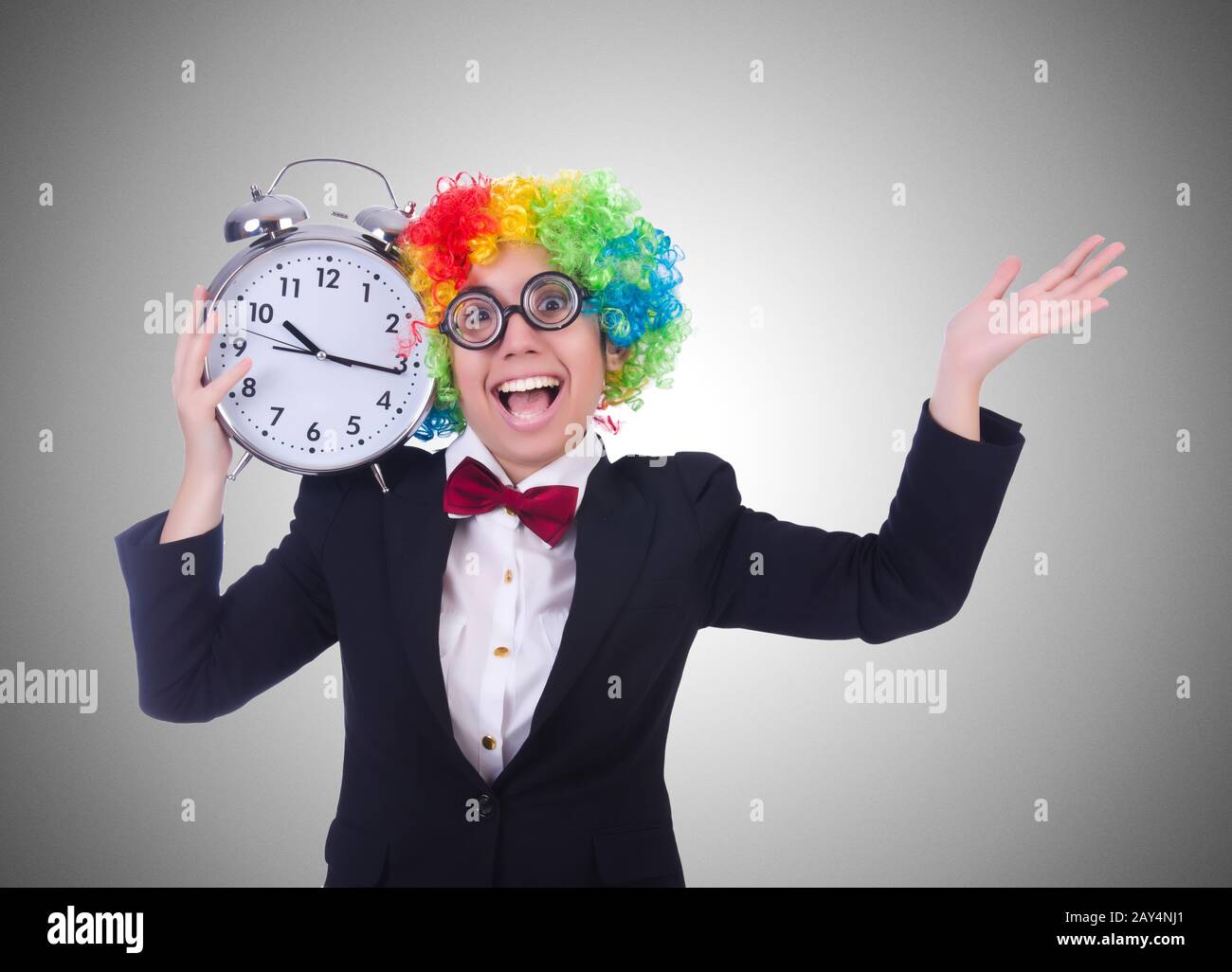 Funny clown with clock on white Stock Photo - Alamy