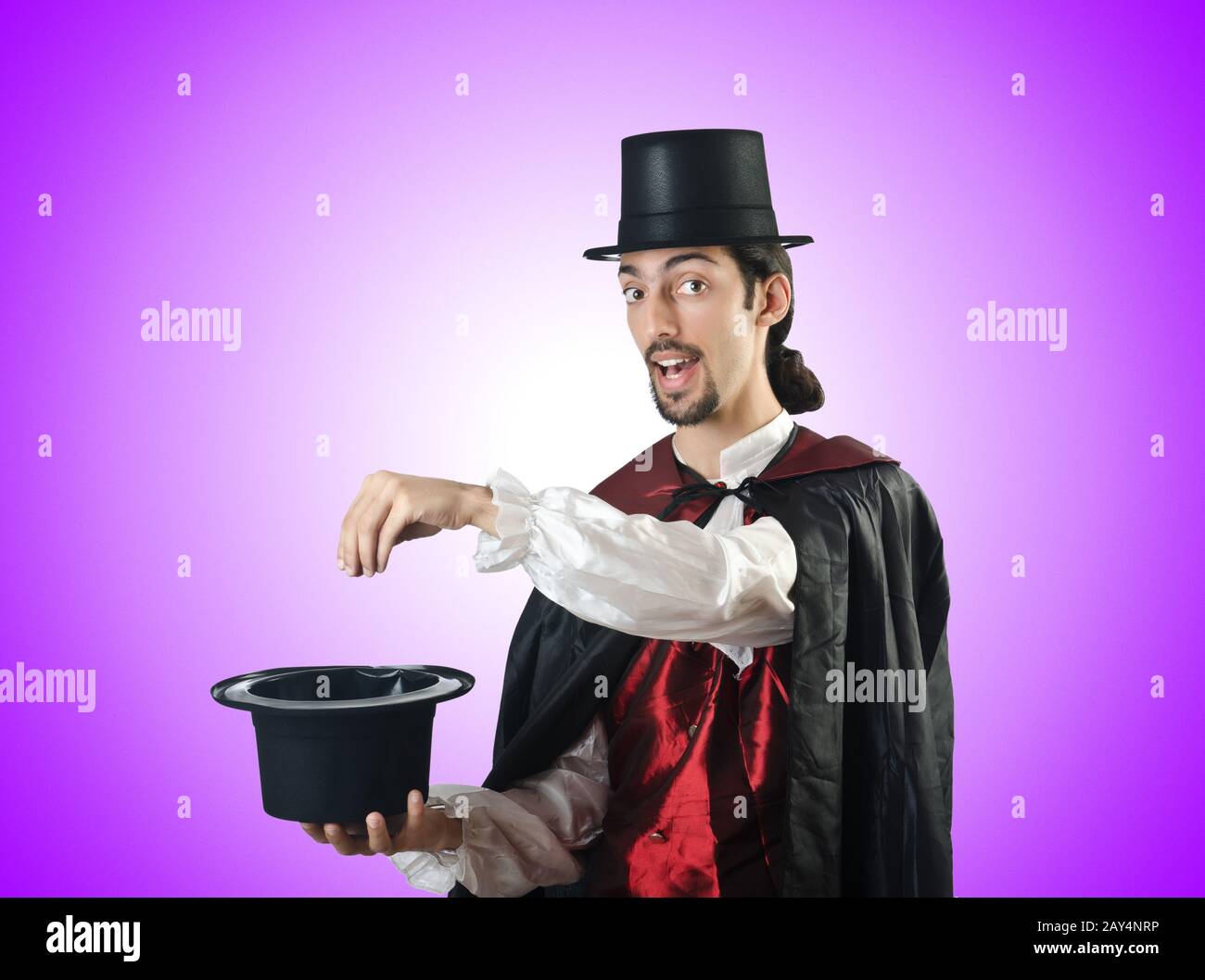Magician doing tricks on white Stock Photo - Alamy