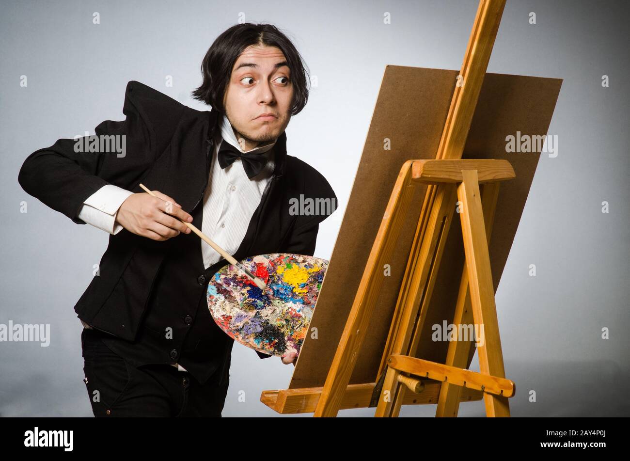 Funny artist in dark studio Stock Photo - Alamy