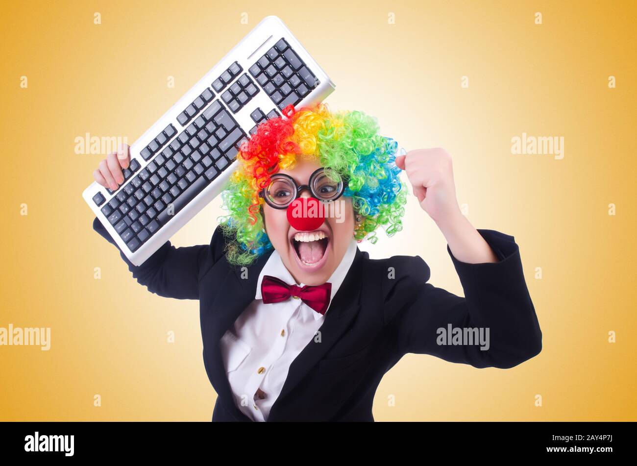 Funny clown with keyboard on white Stock Photo - Alamy