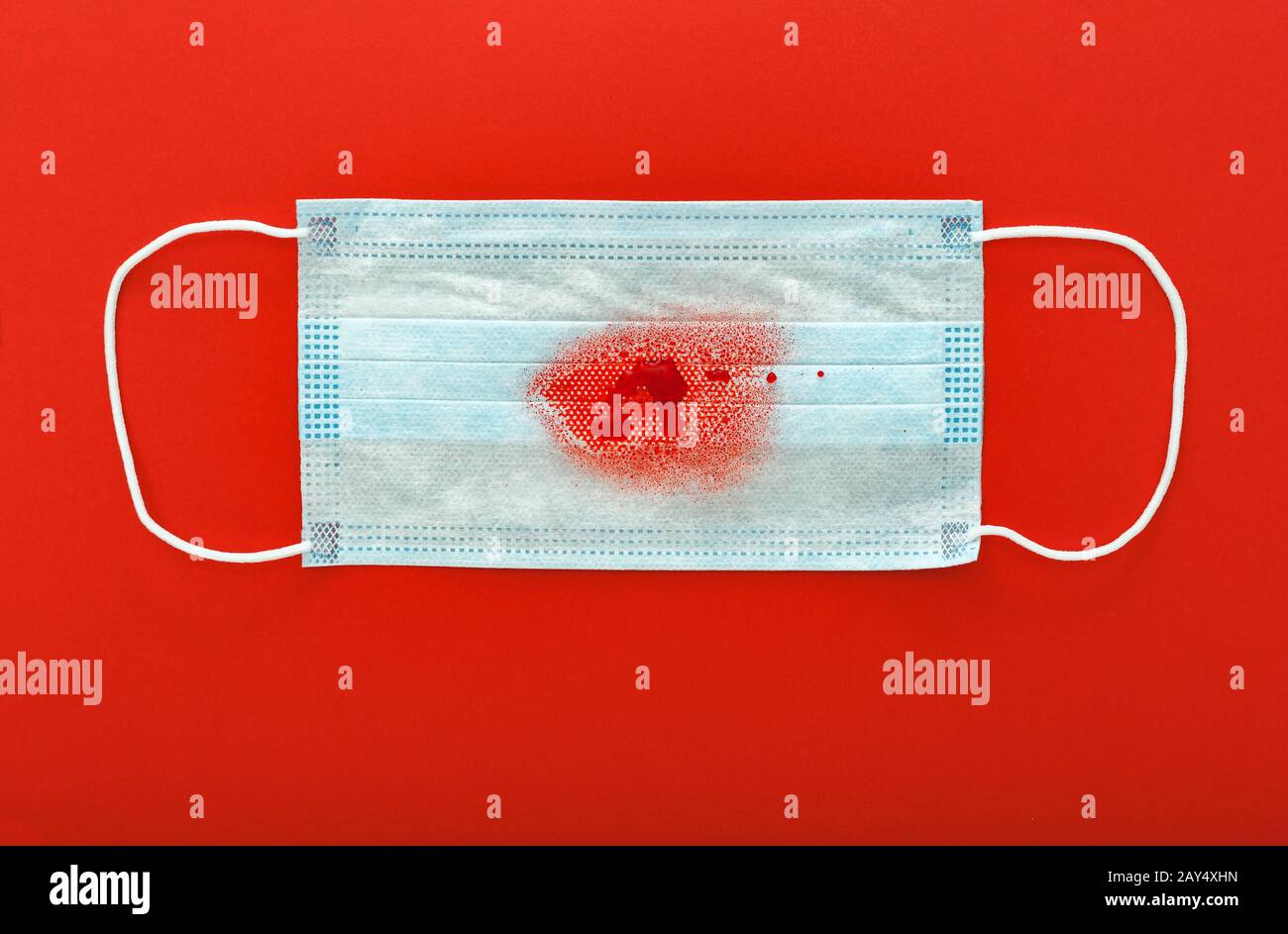 Hemoptysis, coronavirus, protective surgical mask with blood on red ...