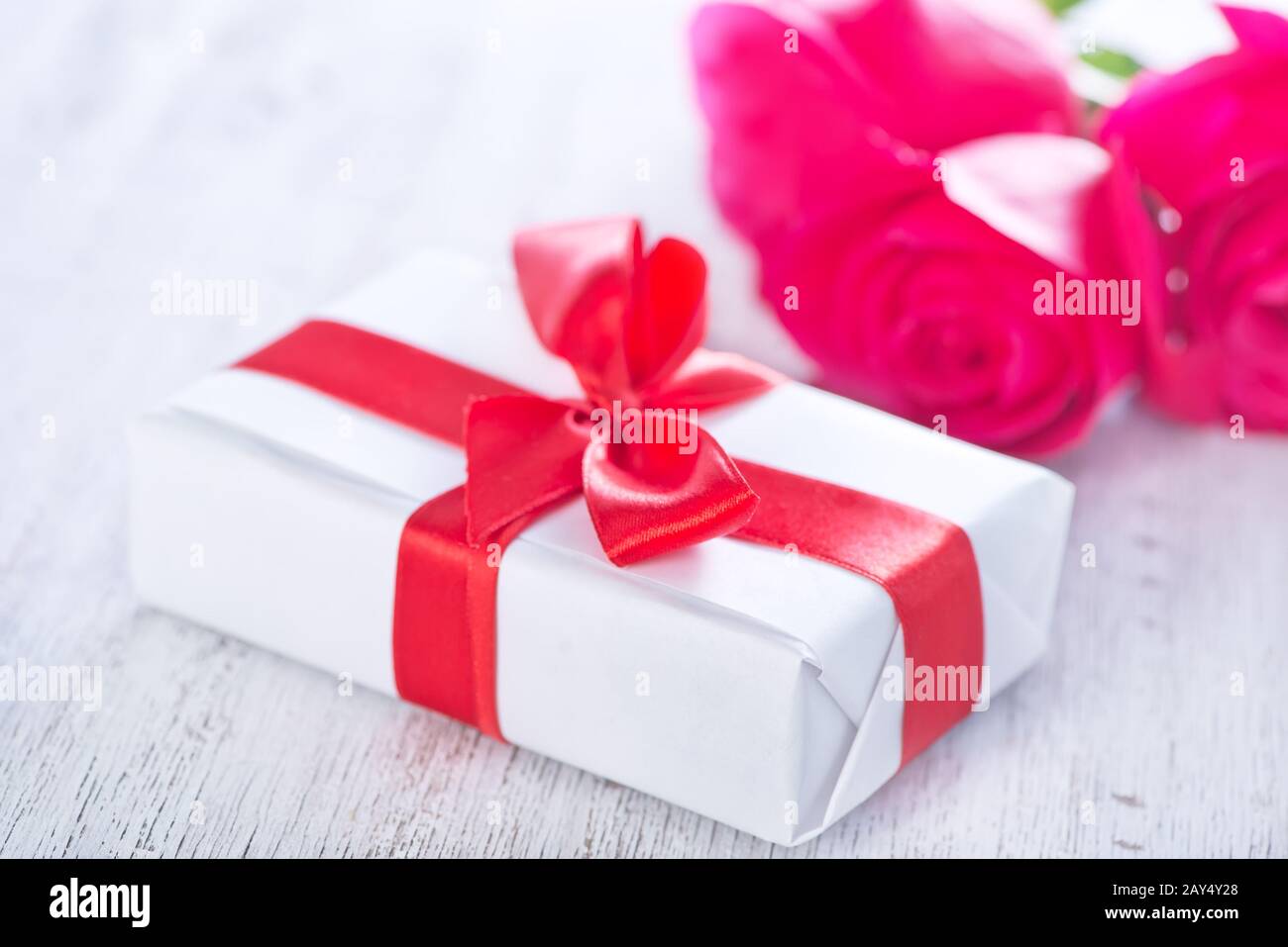 present and red rose Stock Photo - Alamy
