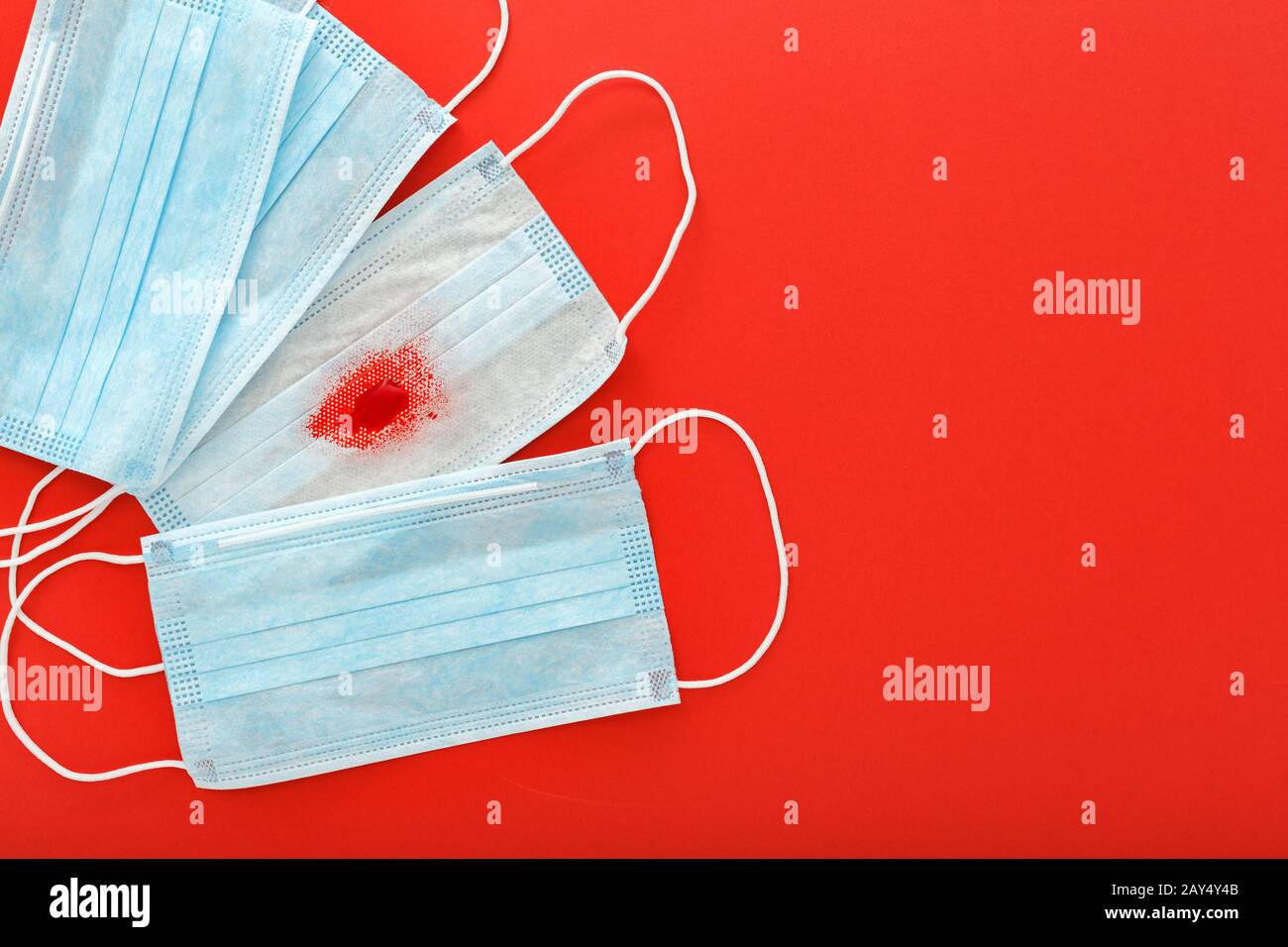 Hemoptysis, coronavirus, protective surgical mask with blood on red ...