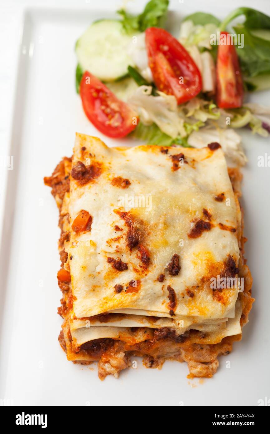 Italian lasagne on a square plate Stock Photo - Alamy