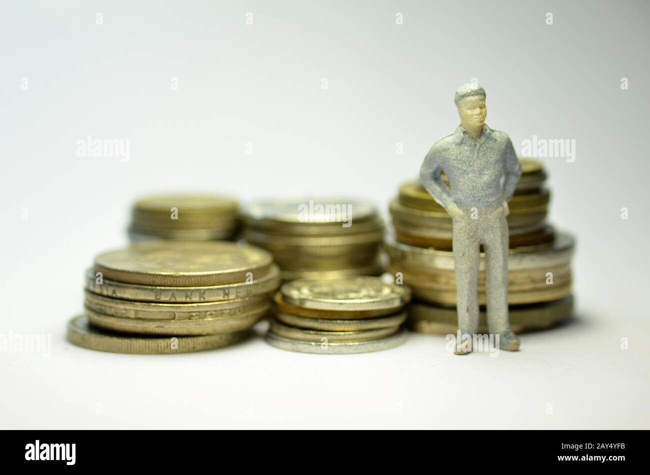 Miniature people with coins Stock Photo - Alamy