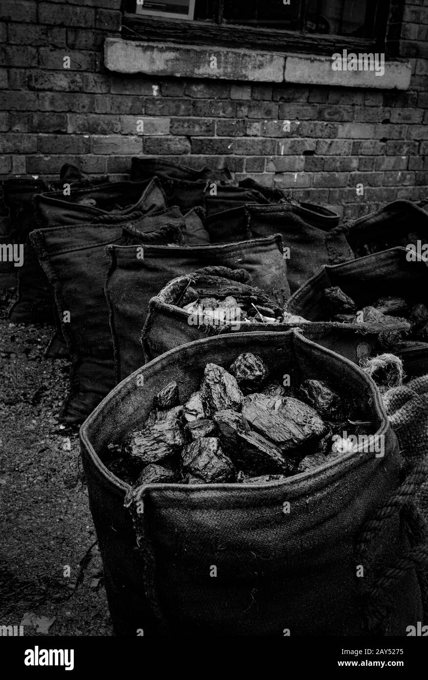 Sacks of coal in black and white Stock Photo - Alamy