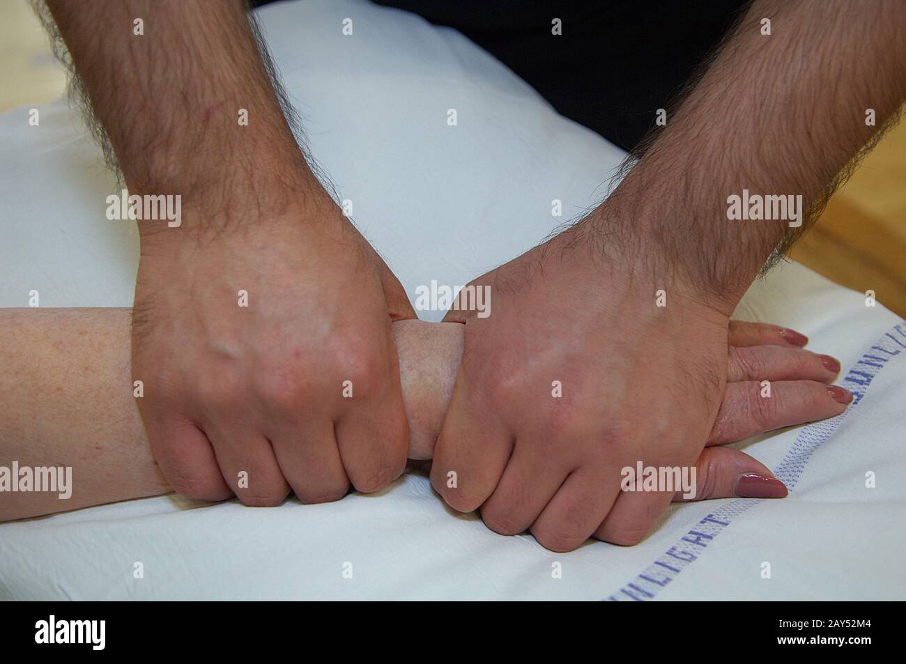 Physio Checking Wrist Joint Stock Photo - Alamy