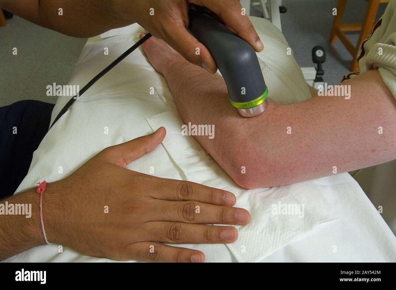 Physio using the Ultrasound Machine on the Elbow Joint Stock Photo - Alamy
