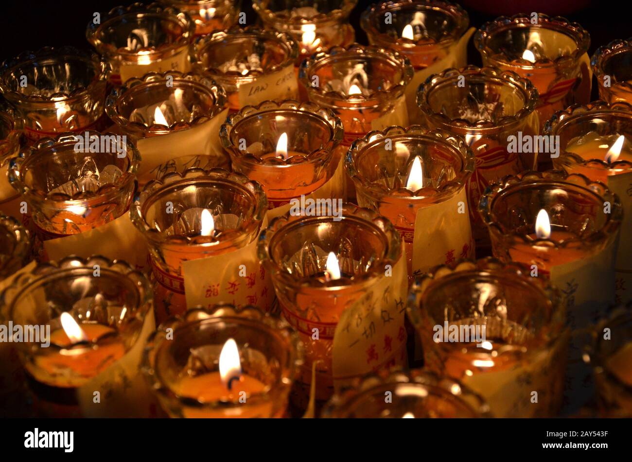 Temple candles in transparent chandeliers Stock Photo - Alamy