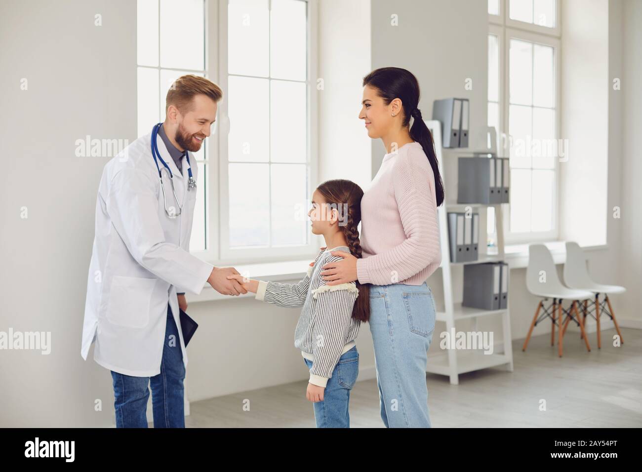 Happy family on a visit to the doctor in the office of a doctor Stock ...