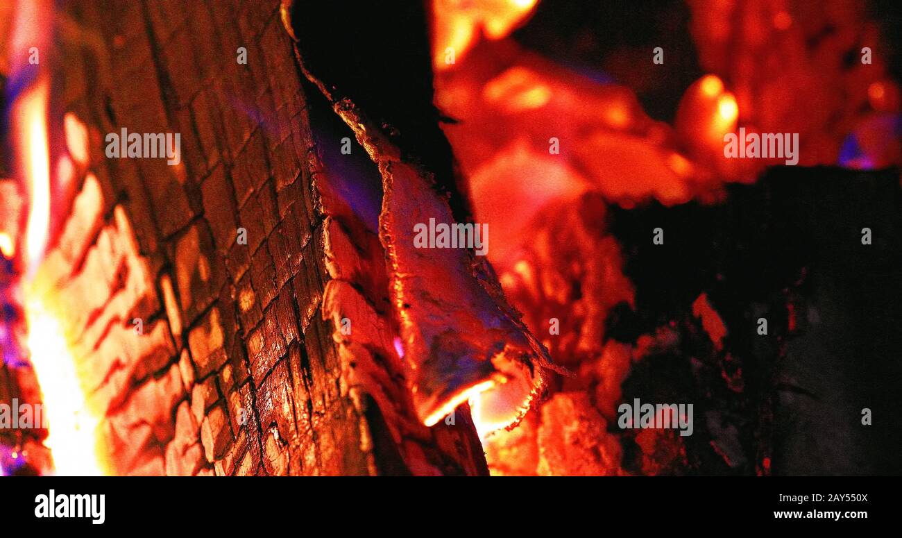 burning red fire and smoldering charcoal close-up, fire flame abstract ...