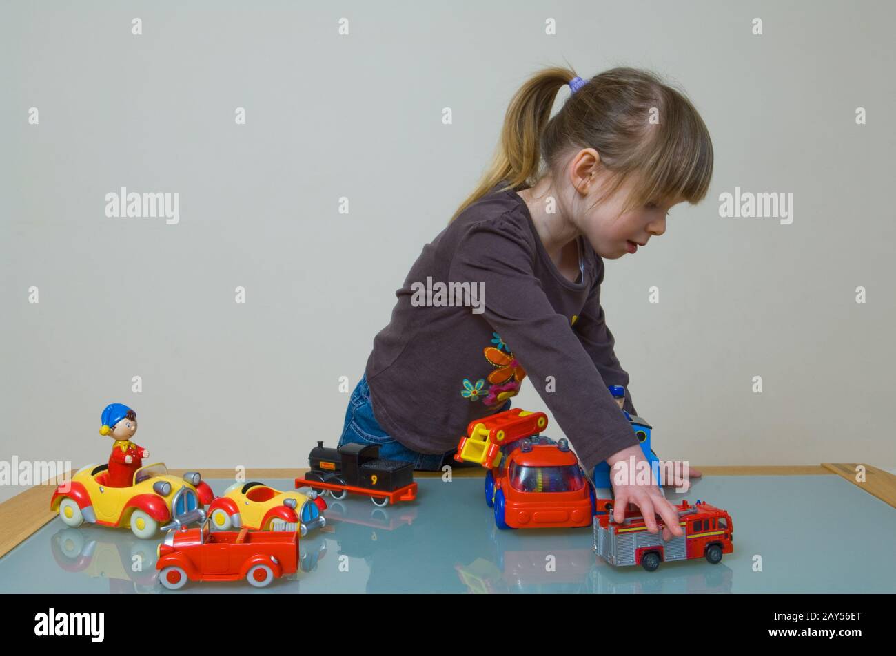 young girl playing with toy cars Stock Photo - Alamy
