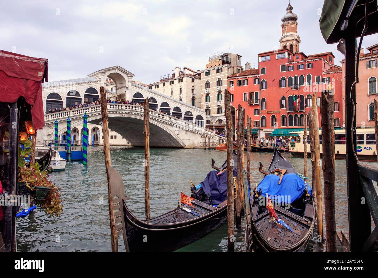 Two gondolas tied on the dock of the Grand Canal by the Rialto bridge ...