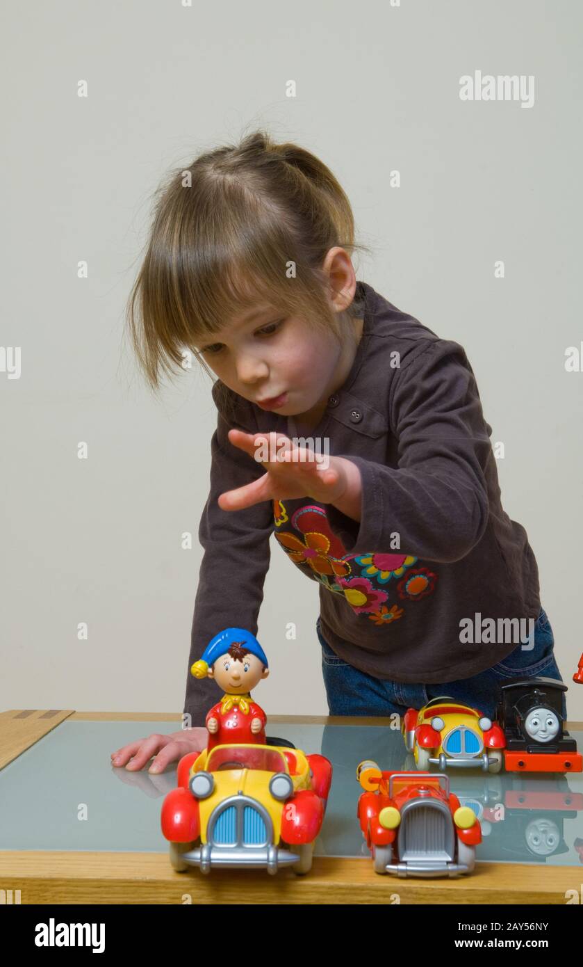 Girl playing with cars hi-res stock photography and images - Alamy