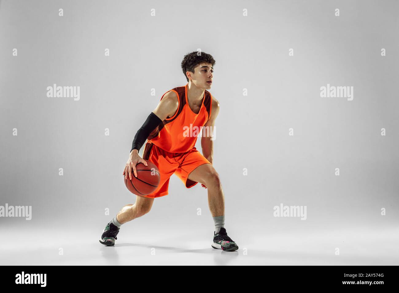 Young basketball player of team wearing sportwear training, practicing ...