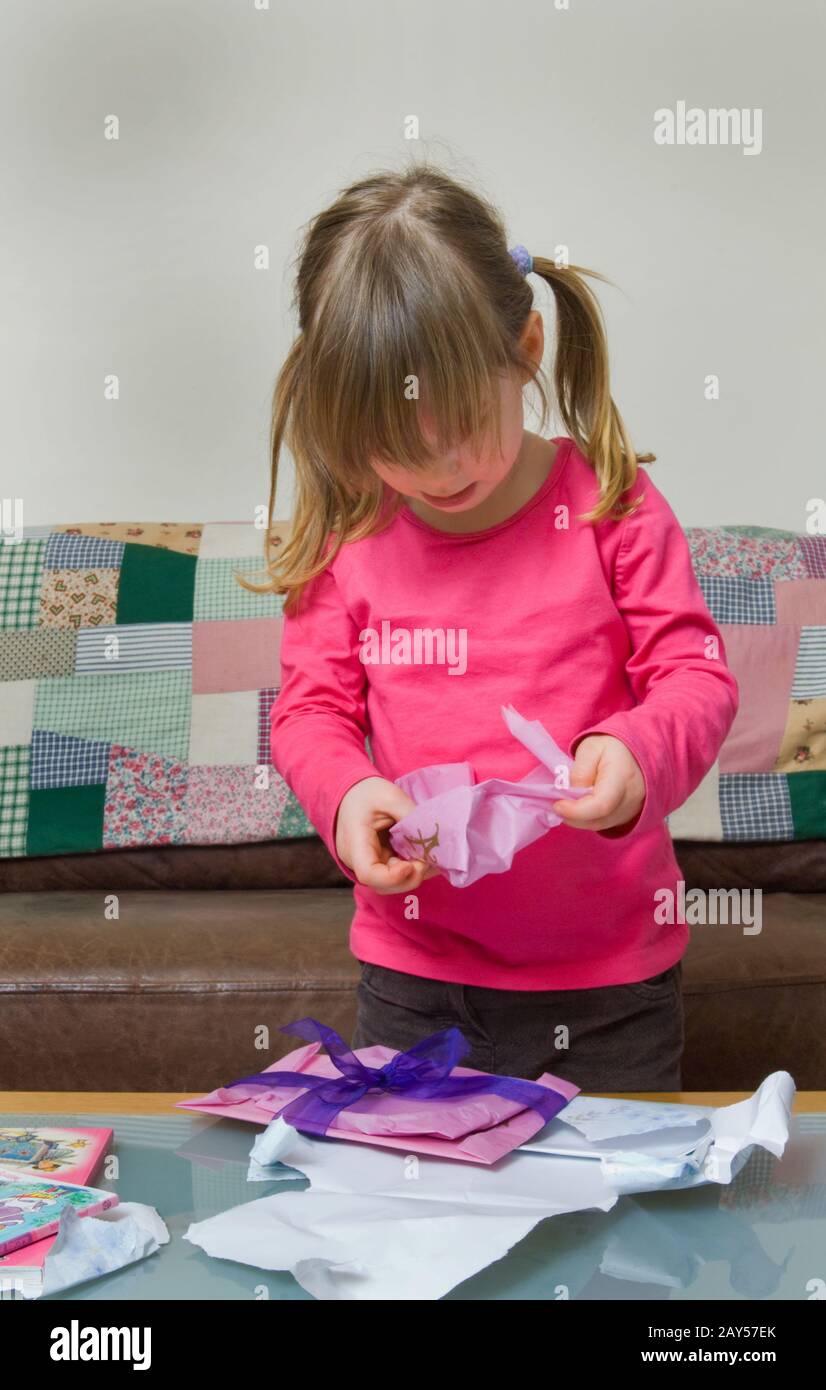 four year old opening a gift Stock Photo - Alamy
