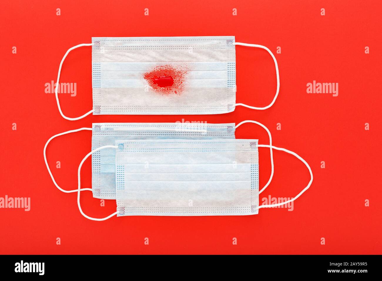 Hemoptysis, coronavirus, protective surgical mask with blood on red ...
