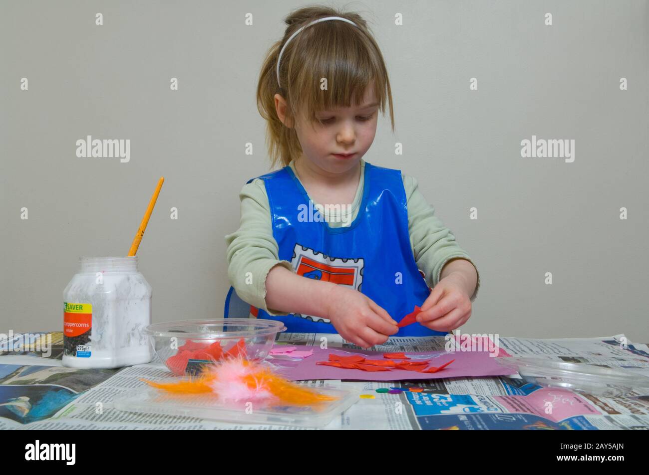 Young girl sticking and gluing Stock Photo - Alamy