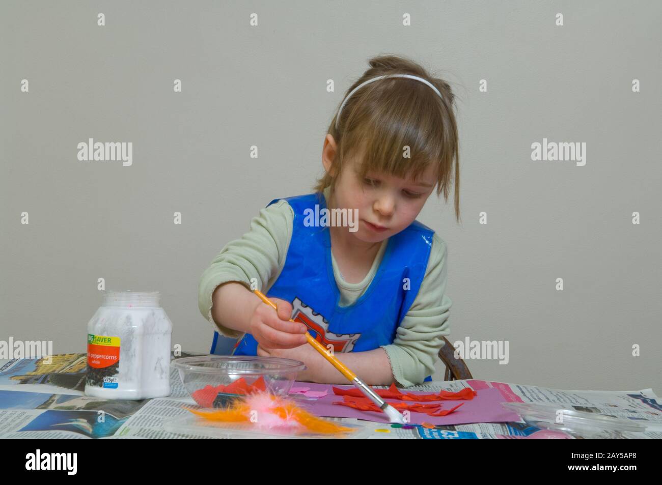 Young girl sticking and gluing Stock Photo - Alamy