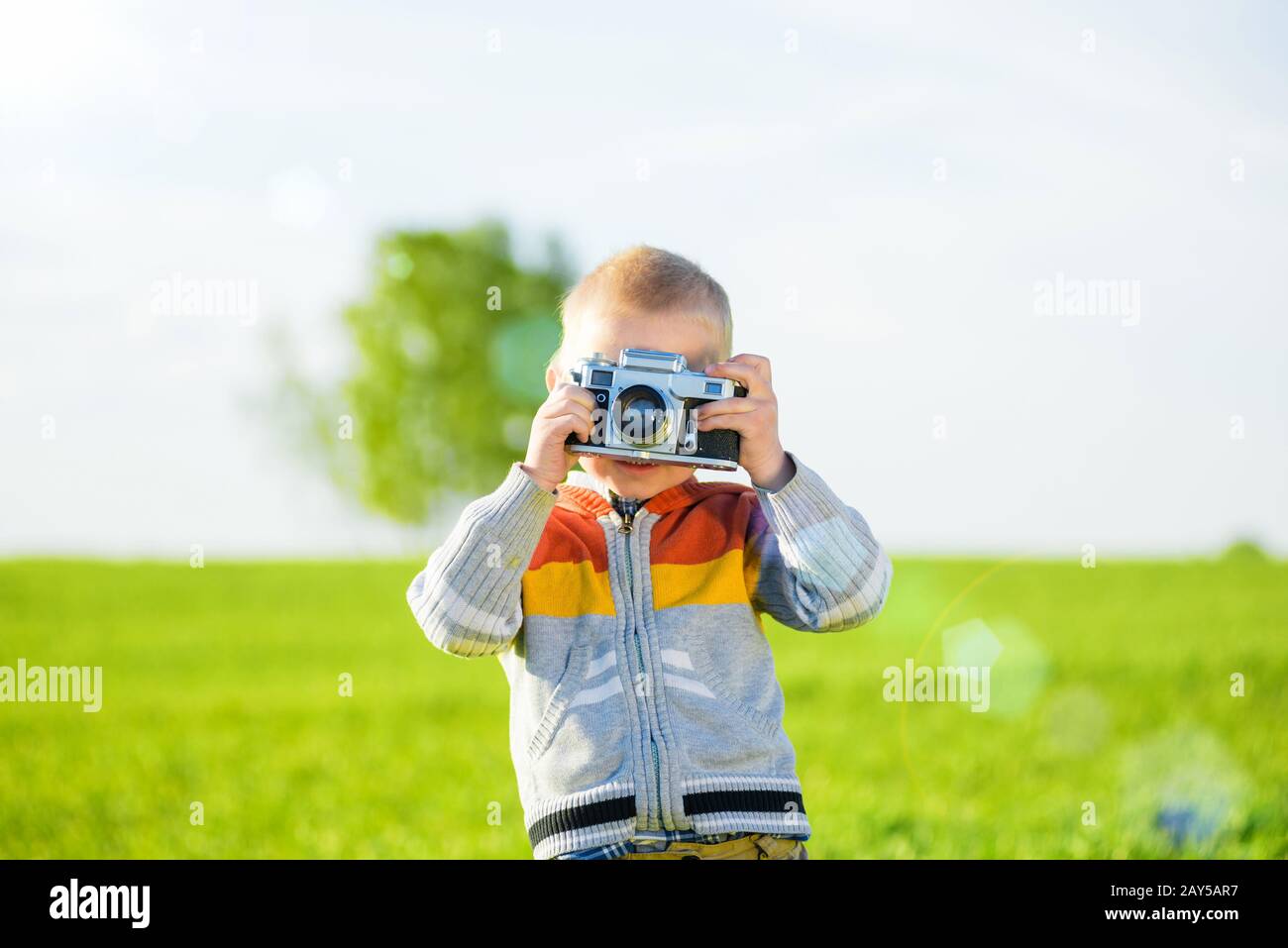 Little boy with an old camera shooting outdoor Stock Photo - Alamy
