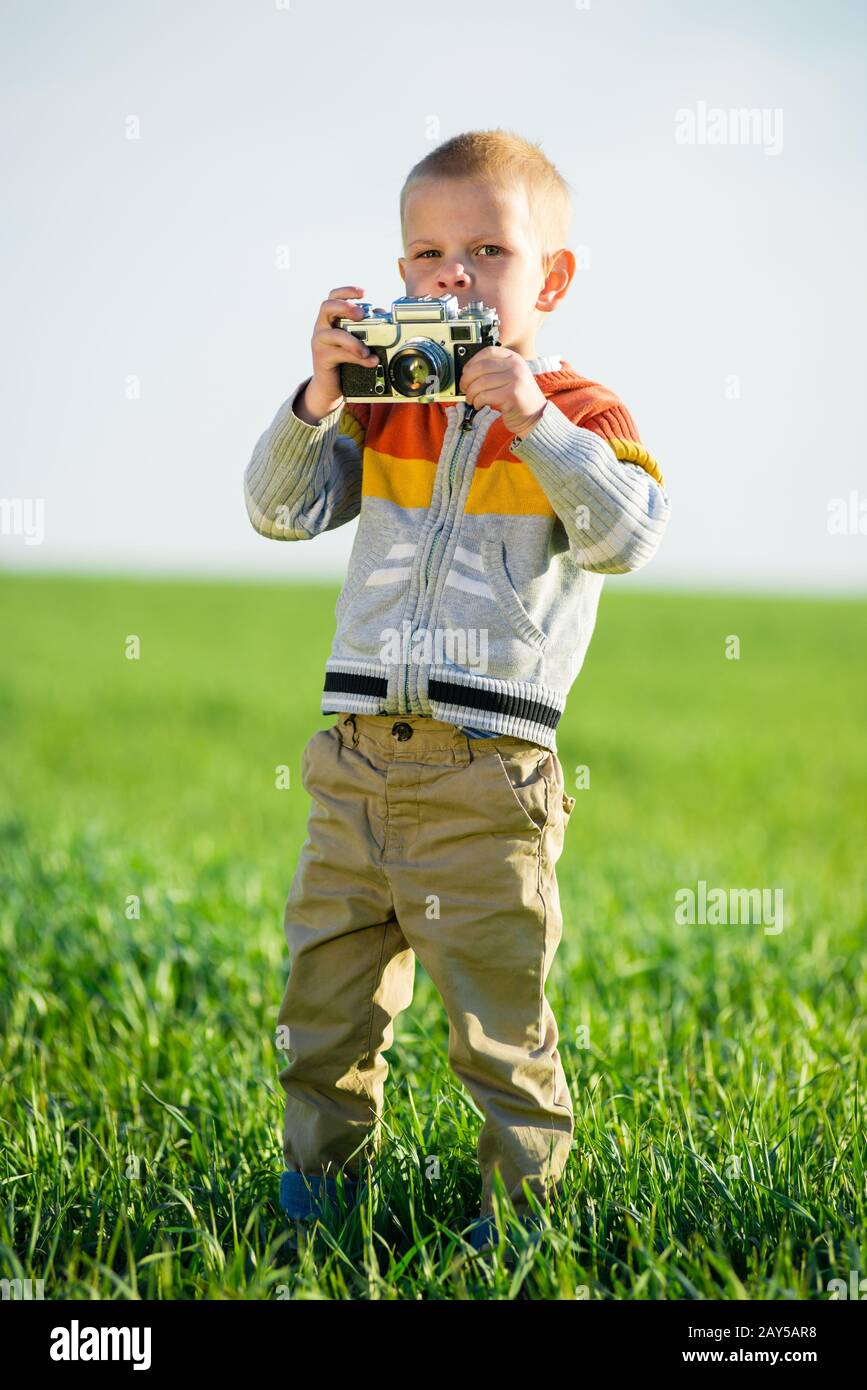Little boy with an old camera shooting outdoor Stock Photo - Alamy
