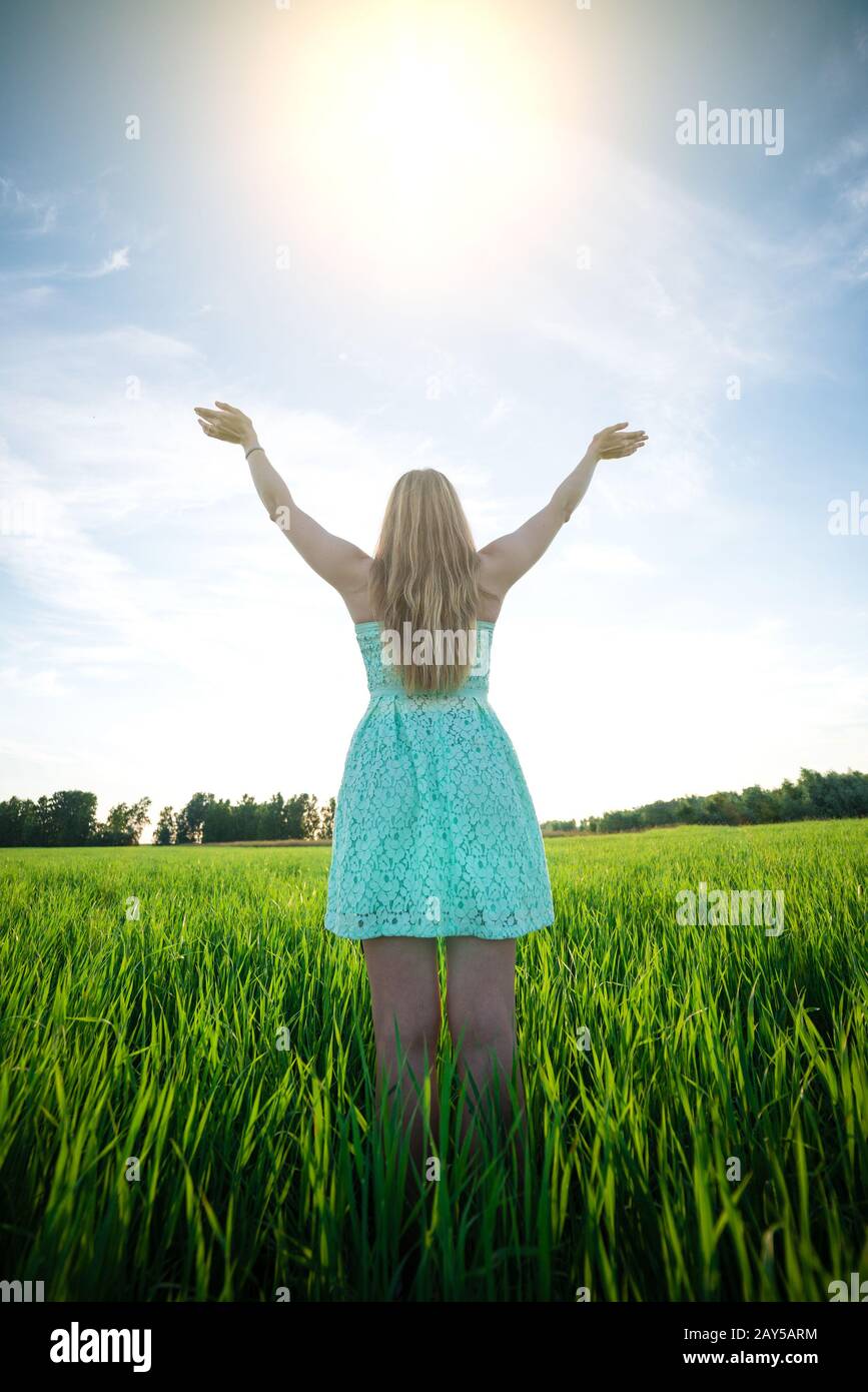 Happiness woman stay outdoor under sunlight of sunset Stock Photo - Alamy