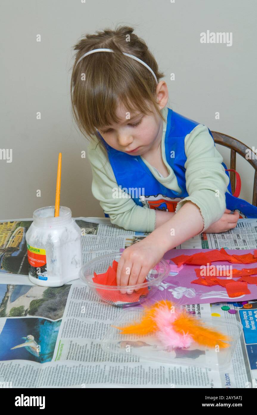 Young girl sticking and gluing Stock Photo - Alamy