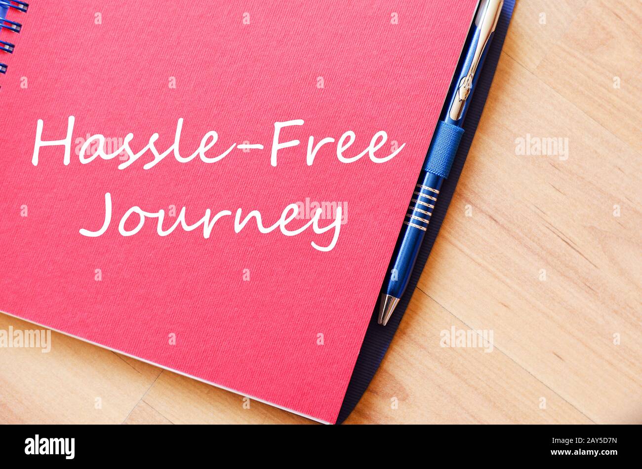 Hassle free journey write on notebook Stock Photo - Alamy